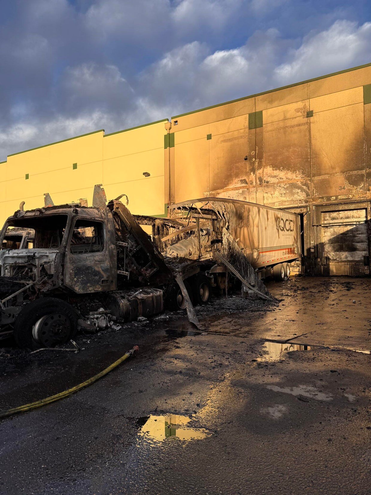 Two-alarm fire damages building, several semi trucks in Aurora ...