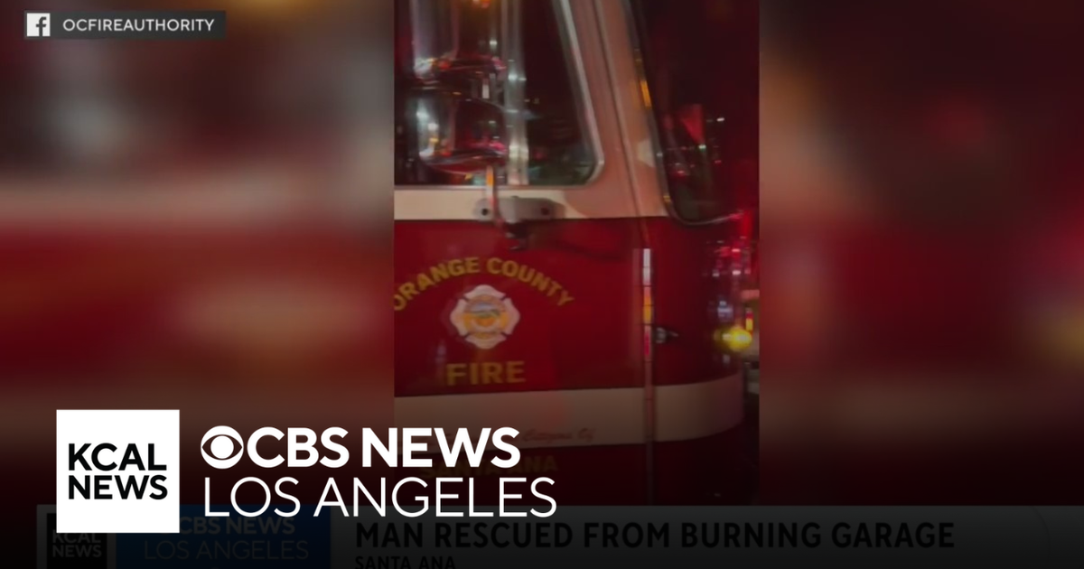 Police rescue man from burning garage in Santa Ana - CBS Los Angeles