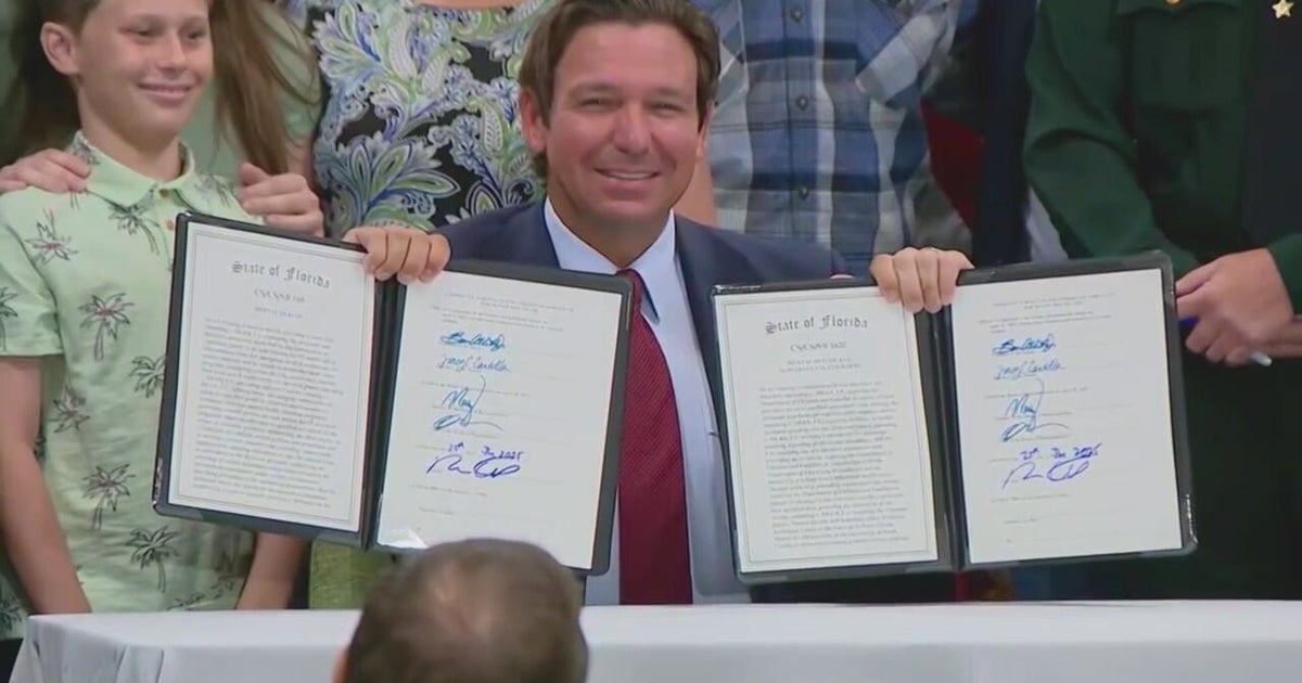 Jim speaks with family members after Gov. Ron DeSantis signs the ...