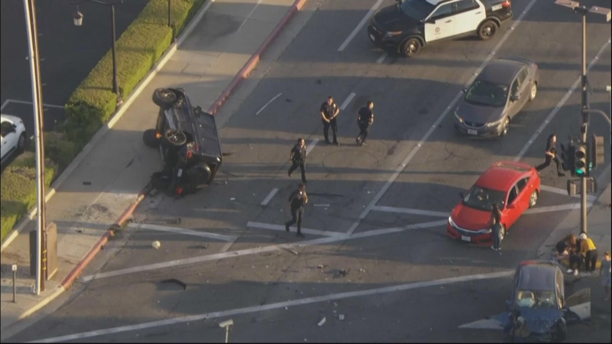 Stolen Mercedes catches on fire, LAPD officer crashes into building during pursuit - CBS Los Angeles