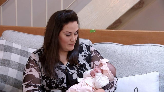 Jackie Blaloch holding her newborn baby girl 
