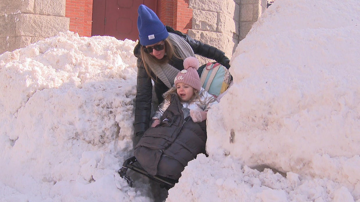 Parents walking with strollers in Boston struggle to navigate snowy ...